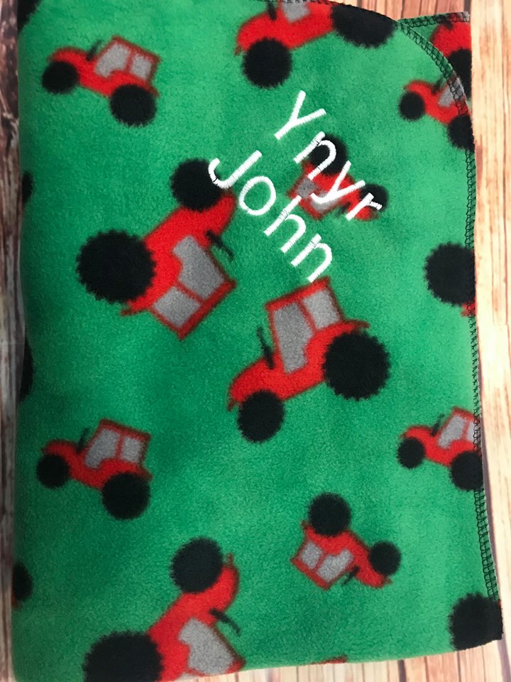 Personalised baby blanket green with red tractors-any name – Pwyth Pistyll